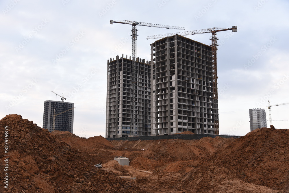 Tower cranes constructing a new residential build. Pouring concrete ...