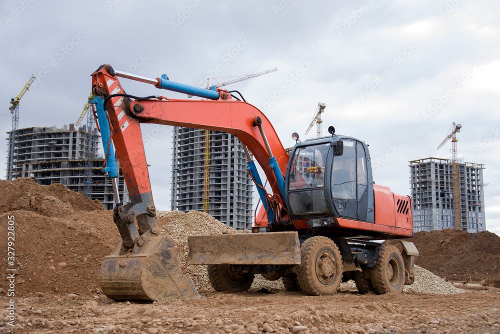 Bucked wheel excavator digs ground at a construction site for ...