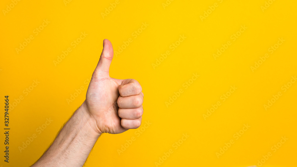 checked and approved. man hand showing big thumb up like sign against ...