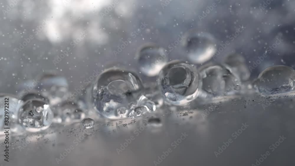 Fluid Bubbles Bounce on Water Resistant Surface with Rain Drops Falling ...