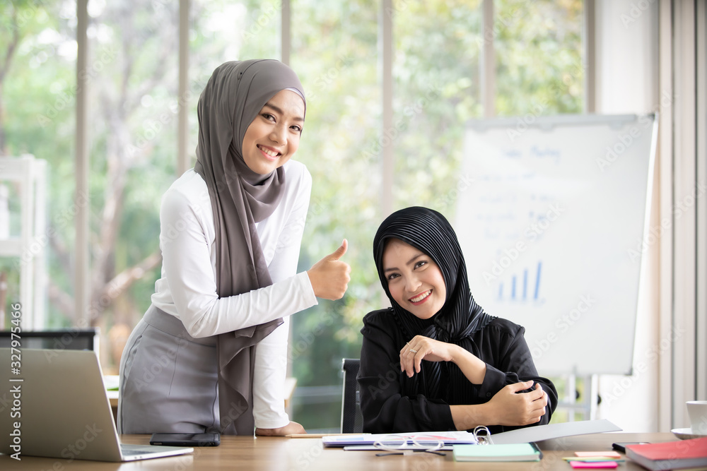 Foto de Asian young muslim business woman working together in office ...