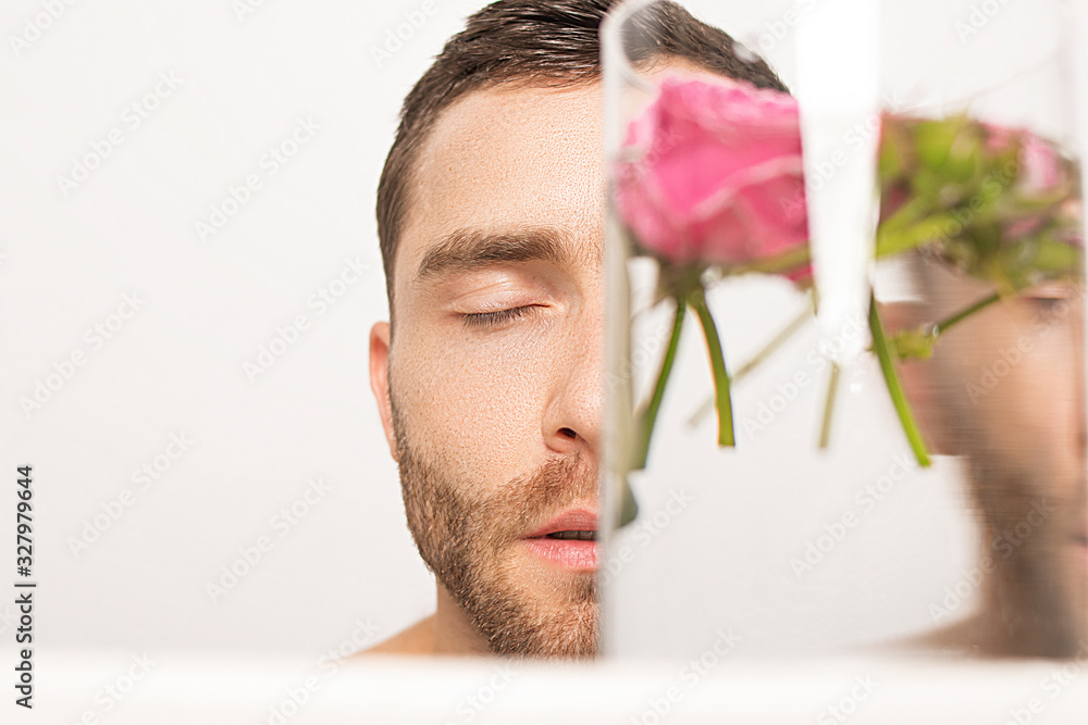 Muscle strong beautiful stripped male model with peony flowers in a ...