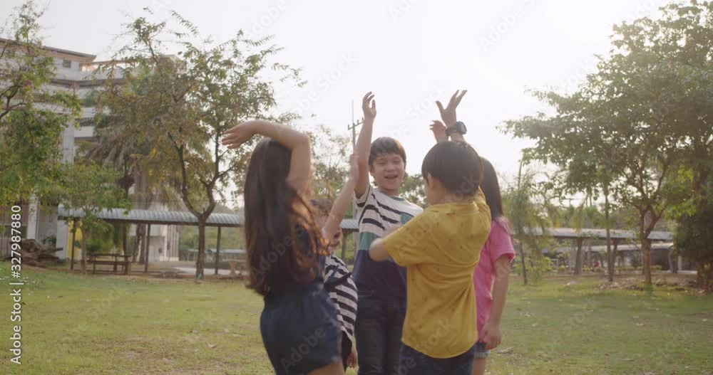 Group of little kids teamwork education graduates put their hands ...