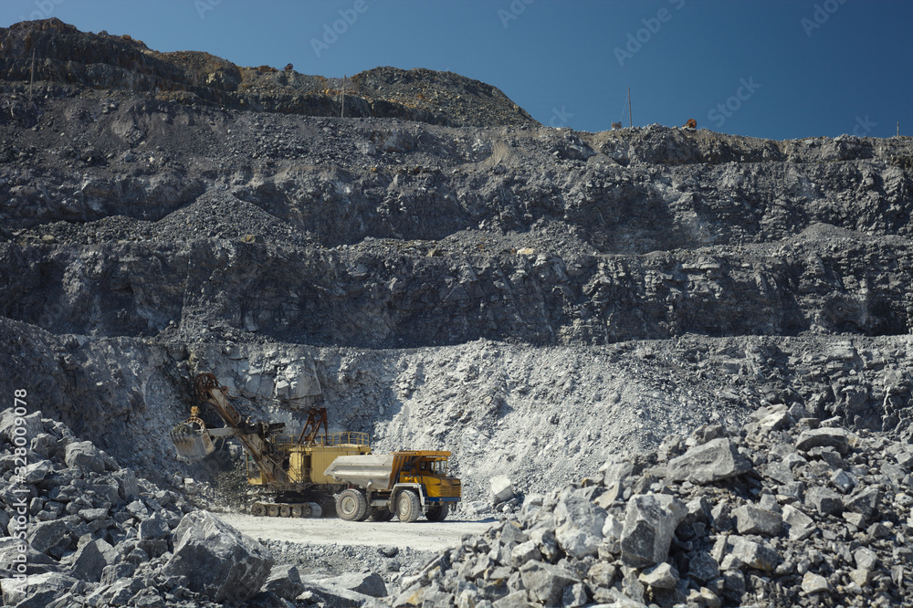 Mining excavator and heavy mining truck in a quarry for the extraction ...