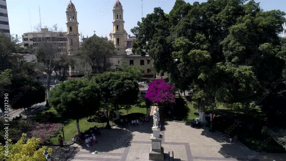 Crane-up aerial drone view move of the main square of Piura city at a ...