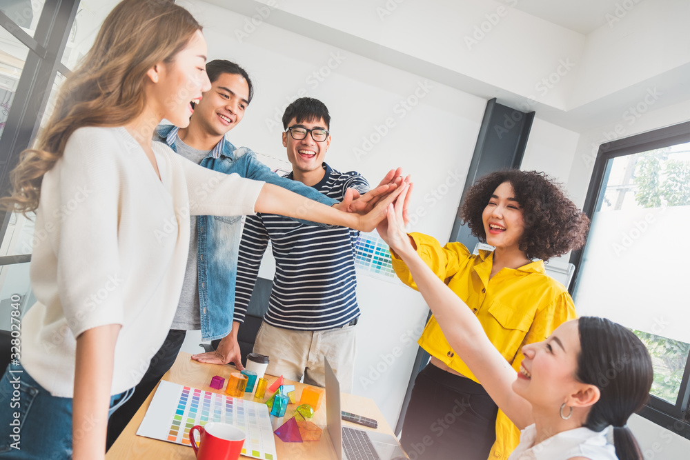 Young Asian people stacking hands for teamwork concept Stock Photo ...