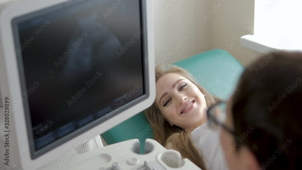 Process of ultrasonography, doctor checking baby in happy pregnant ...