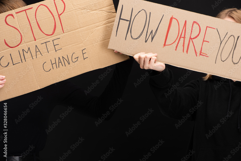 Cropped view of women with placards with stop climate change and how ...