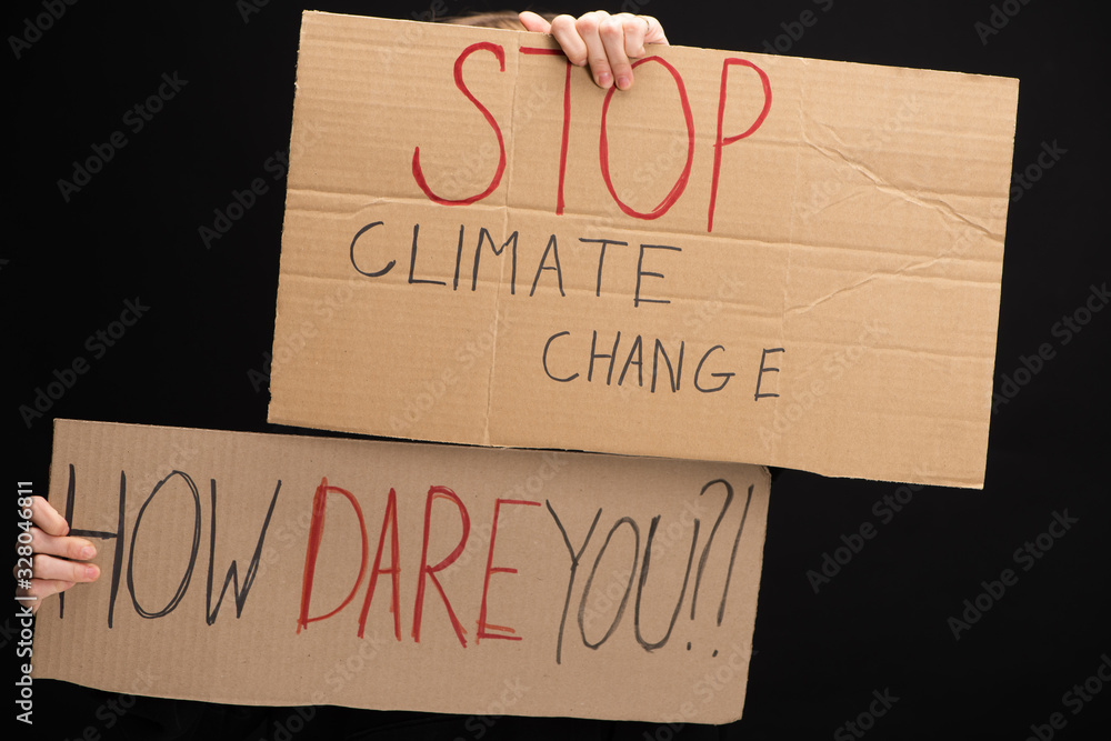 Cropped view of woman with placards with stop climate change and how ...