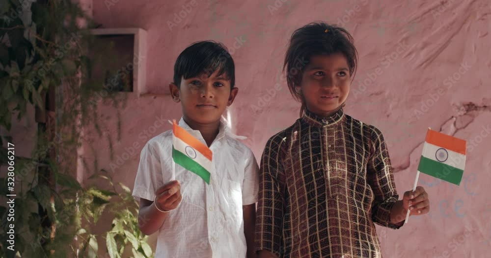 Indian kids raising and wave the Indian national flag or the tiranga ...