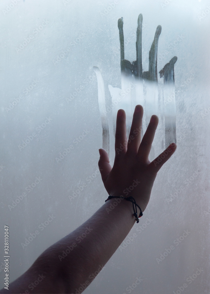 Girl's hand on the glass. Handprint on wet glass. Smeared by hand mark ...