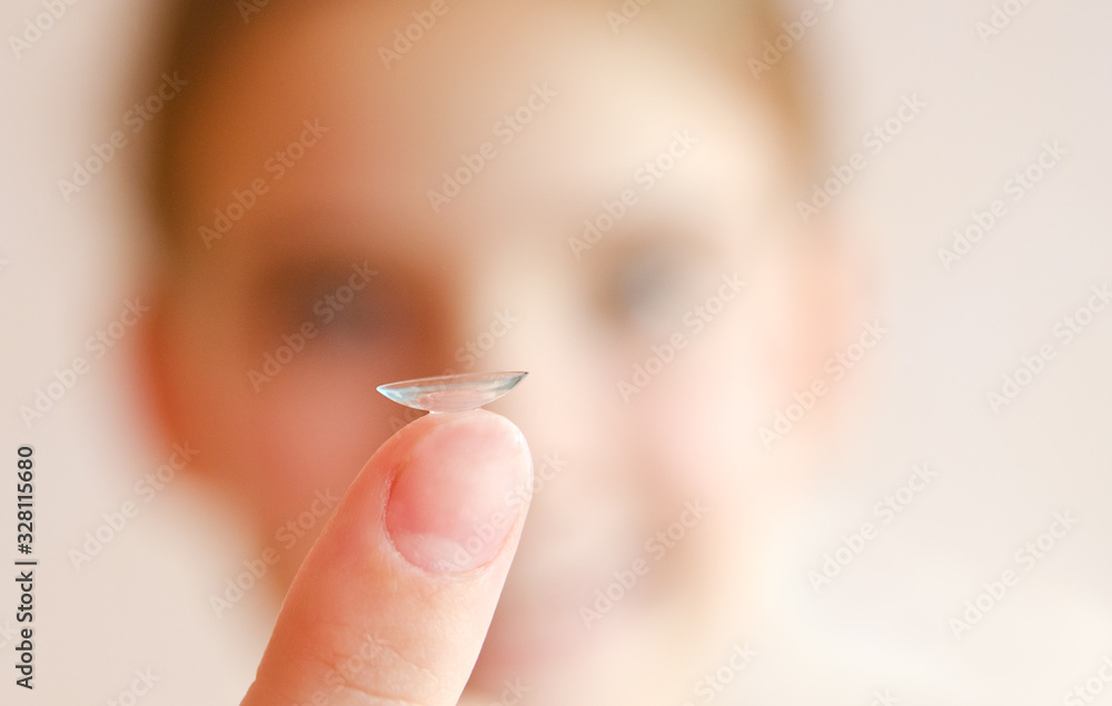 Little girl child putting contact lens into her eye Stock Photo | Adobe ...