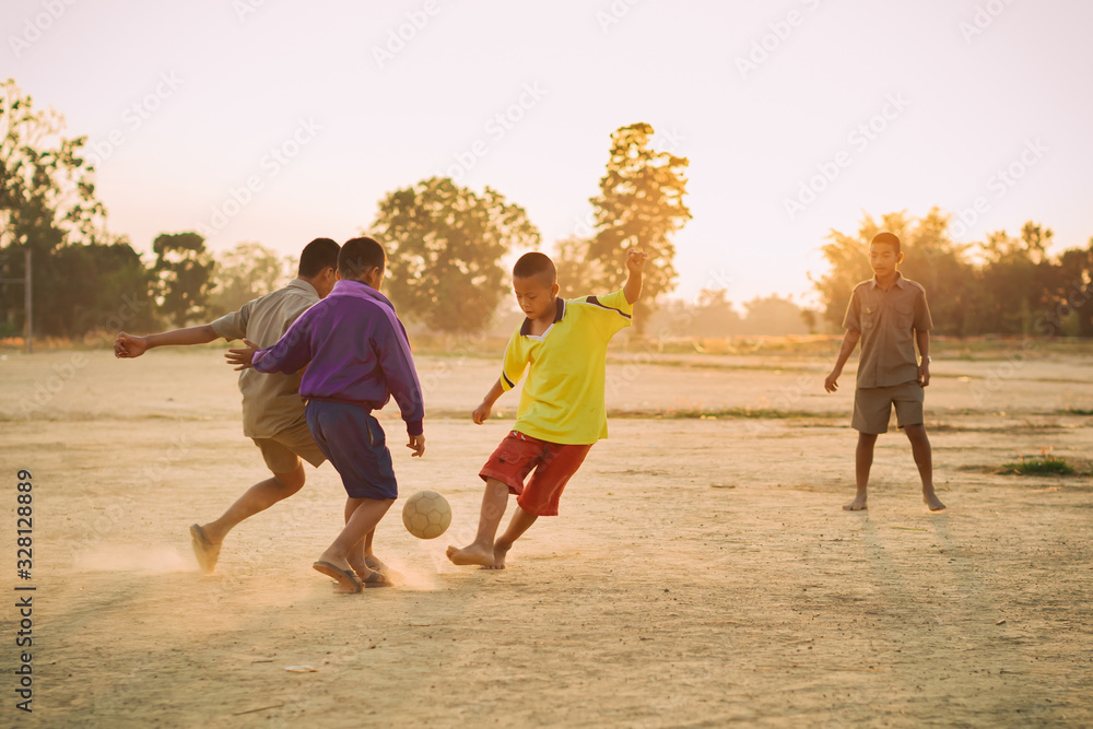An action picture of a group of kids playing soccer football for ...