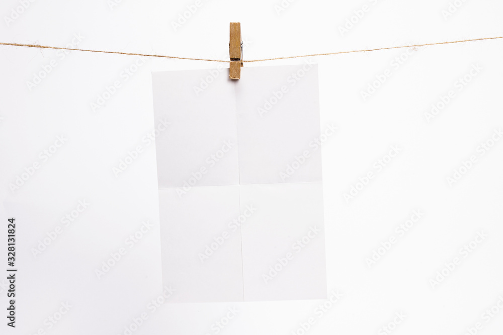 Empty paper sheet for notes, frame that hang on a rope with clothespins ...