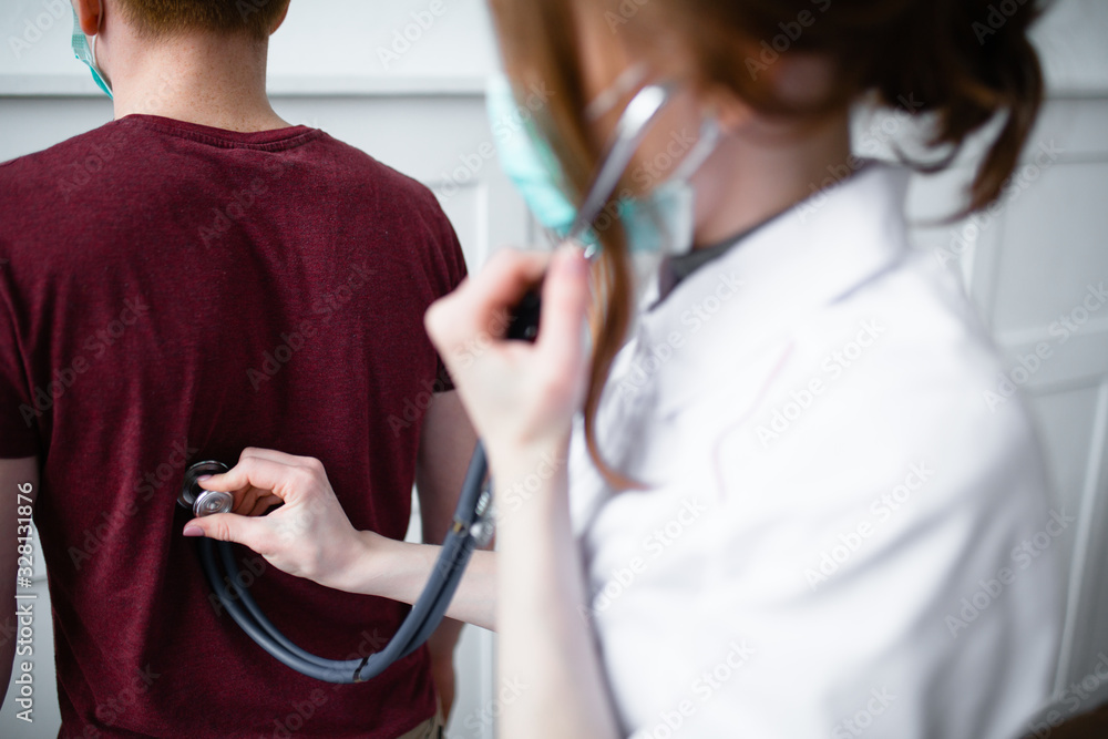 Therapist with a stethoscope listens to the patient's heartbeat Stock ...