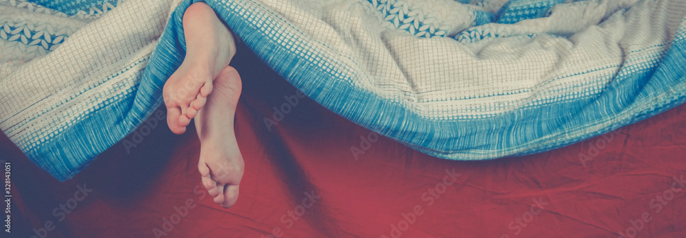 Sleep and relax concept. Beautiful groomed bare feet of cute little ...