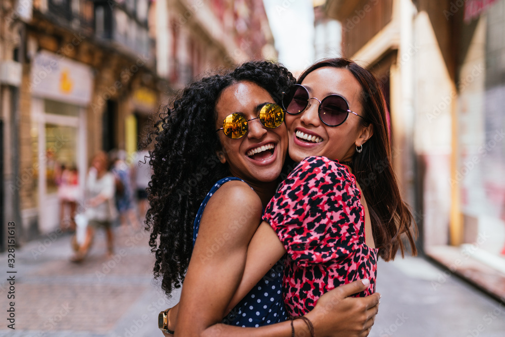 Two best girl friends embracing and wearing sunglasses sharing h Stock ...