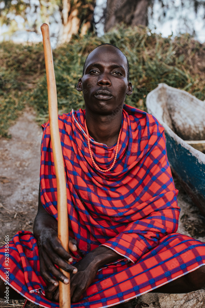 Maasai Man on the beach in front of sea Stock Photo | Adobe Stock