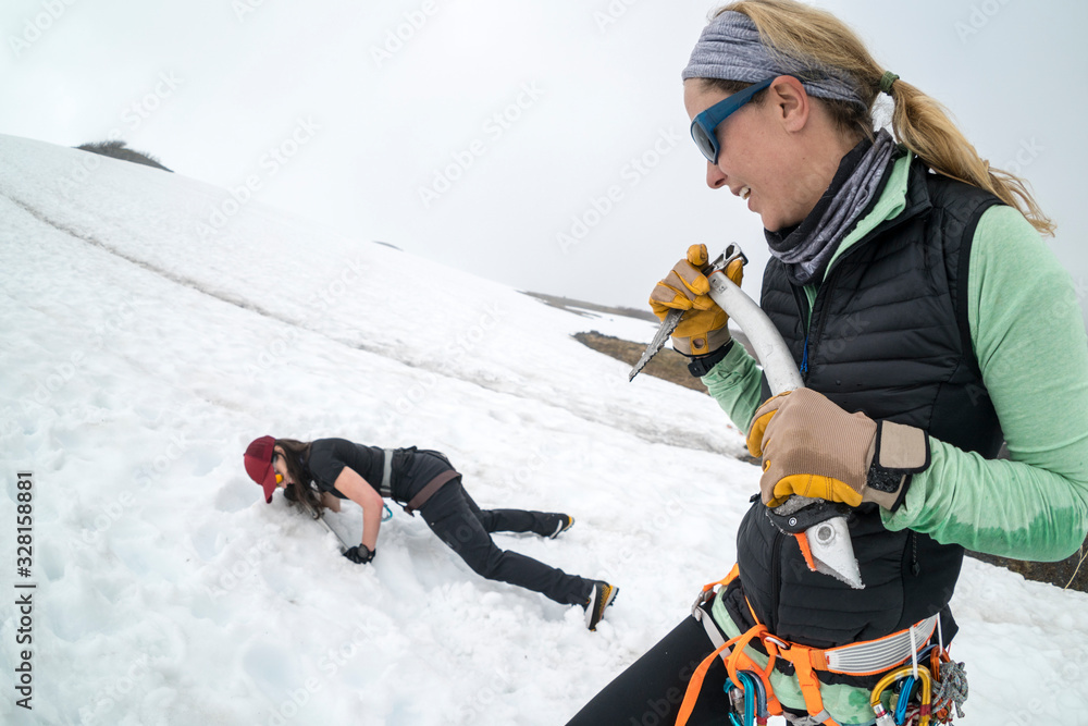 One female mountaineer teaches the other how to self-arrest on Mt ...