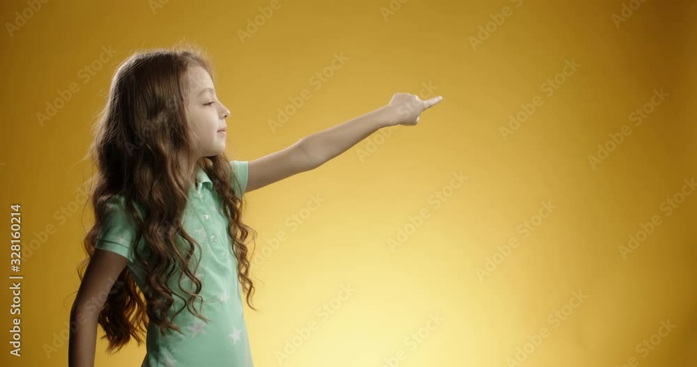 Little caucasian girl points her hands in air, visualising use of ...