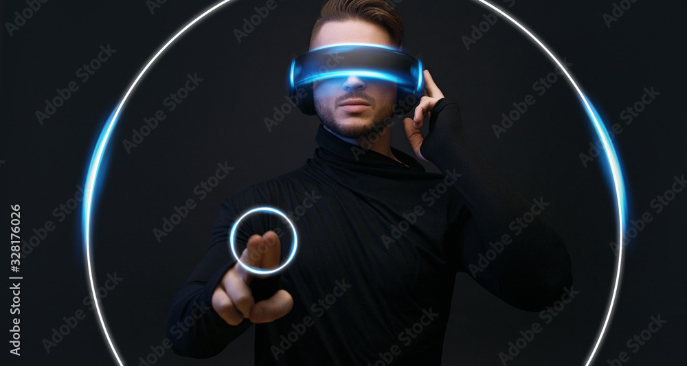 Guy using VR helmet scrolling invisible screen while interacting with ...
