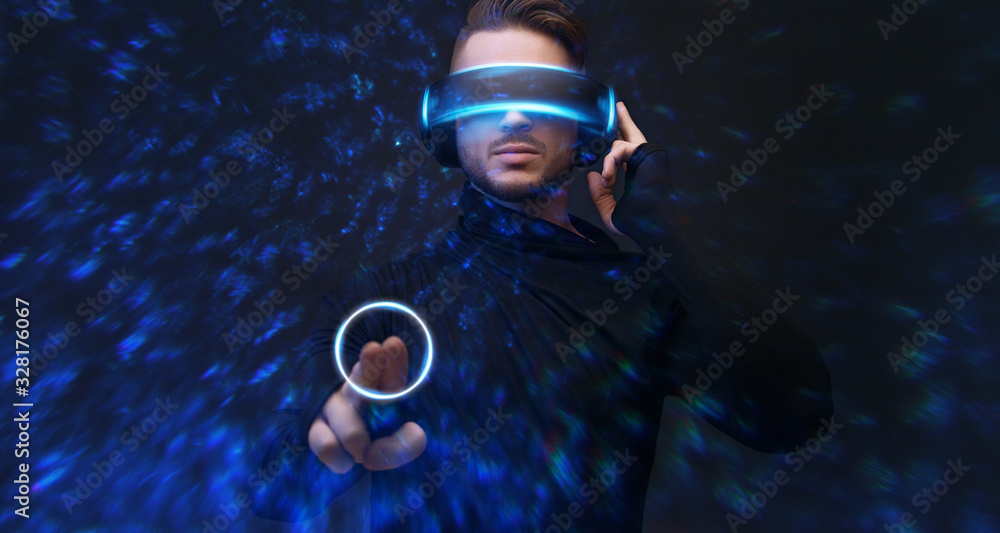 Guy using VR helmet scrolling invisible screen while interacting with ...