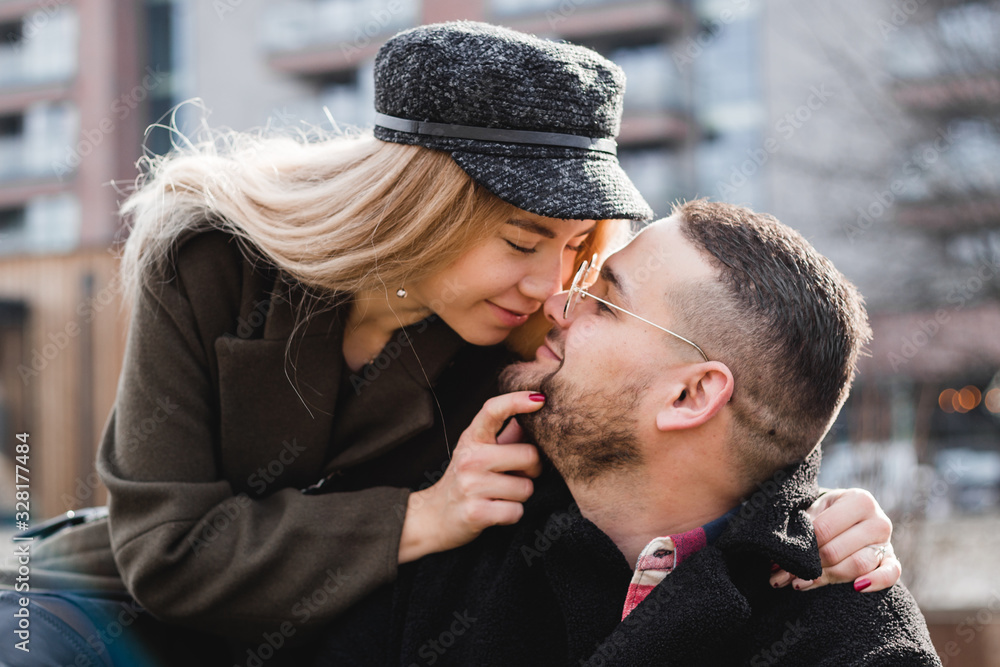 Loving couple kissing outdoor. Cute couple of hipsters is walking in ...
