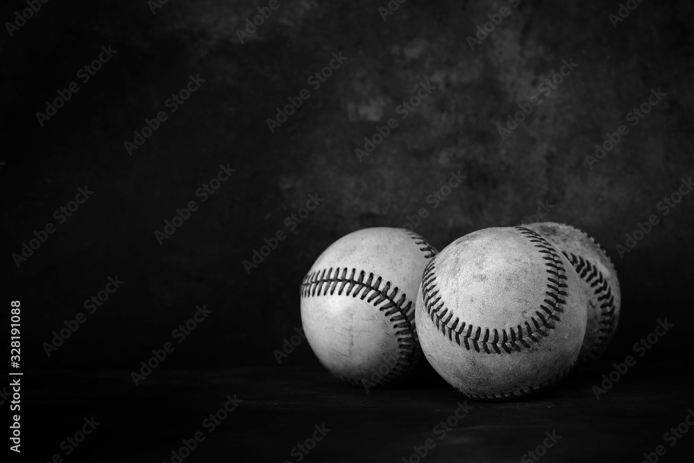 Group of old rugged baseballs with black texture background, copy space ...