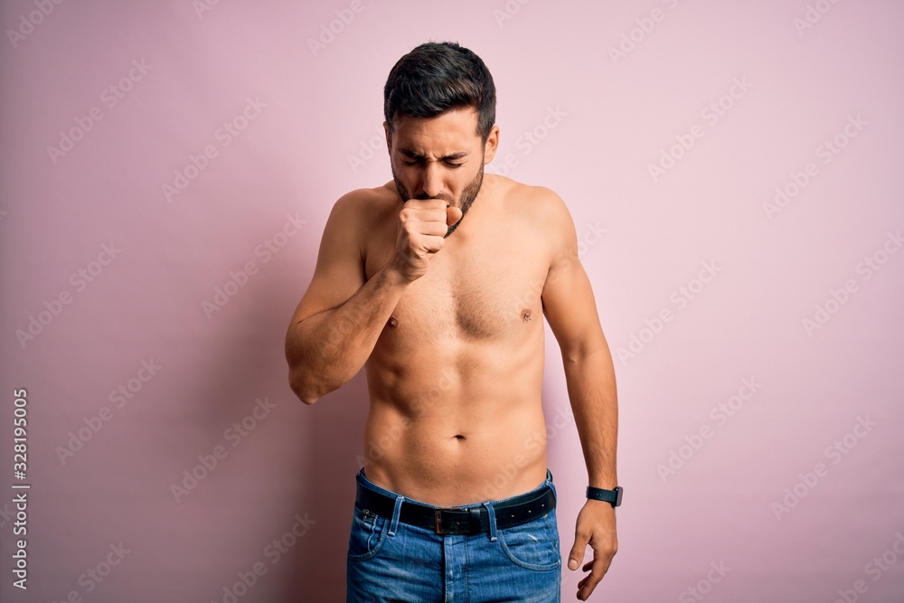 Young handsome strong man with beard shirtless standing over isolated ...