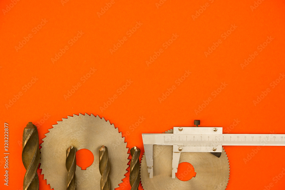 On a bright orange background, a top view of a tool disk cutters ...