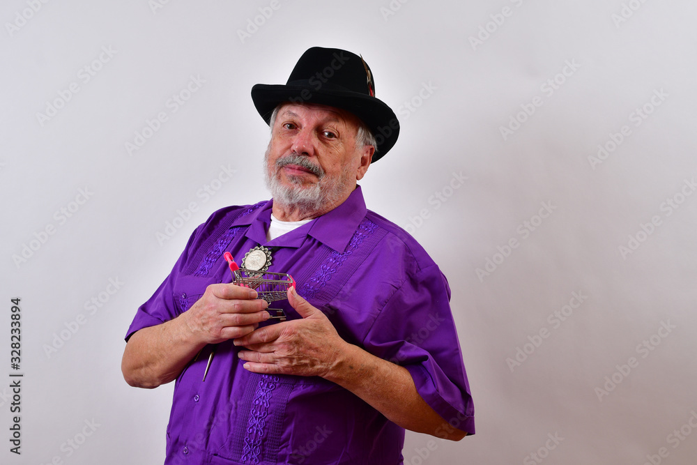 Old man holds his shopping cart close to his hear. Dapper old man with ...