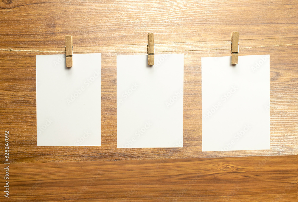Empty paper frames that hang on a rope with clothespins and on wooden ...