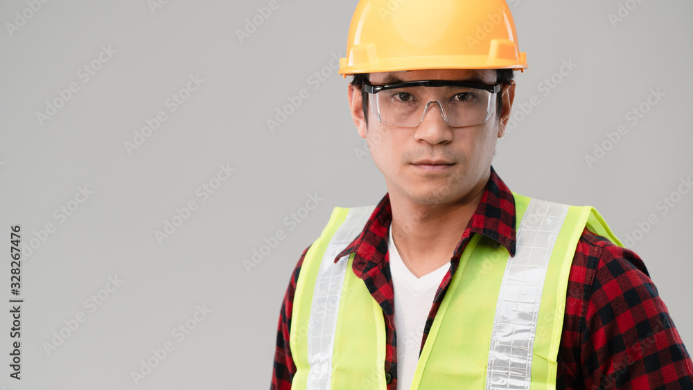 portrait of young Asian foreman wearing yellow hard hat or safety ...
