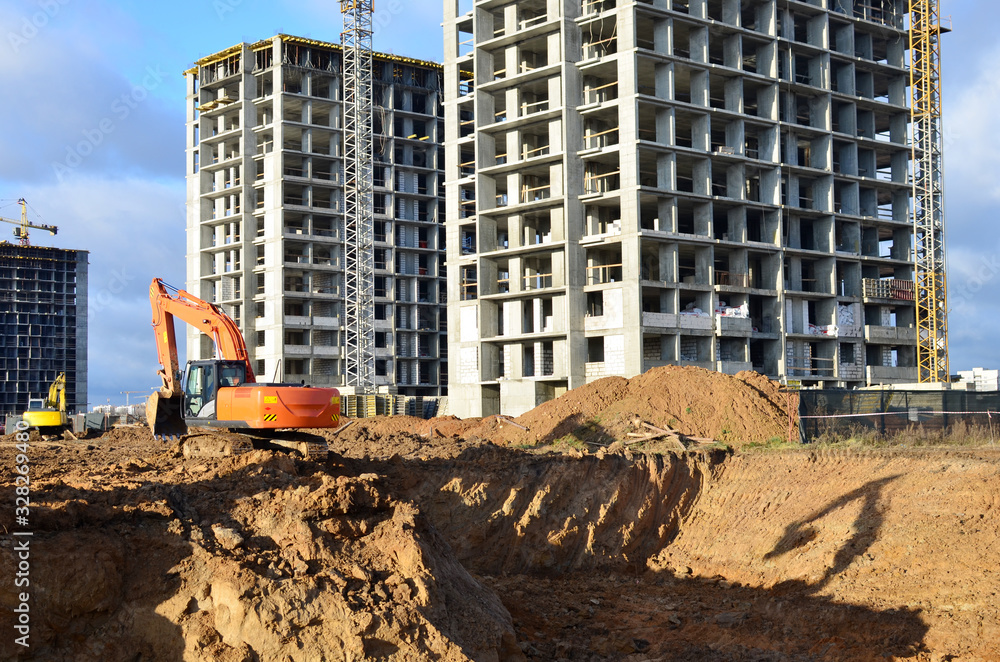 Excavator digs ground at a construction site for installing concrete ...