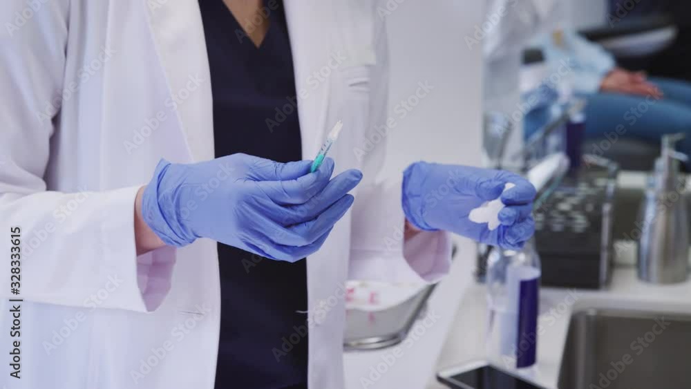 Close up of beautician or doctor with syringe explaining procedure ...