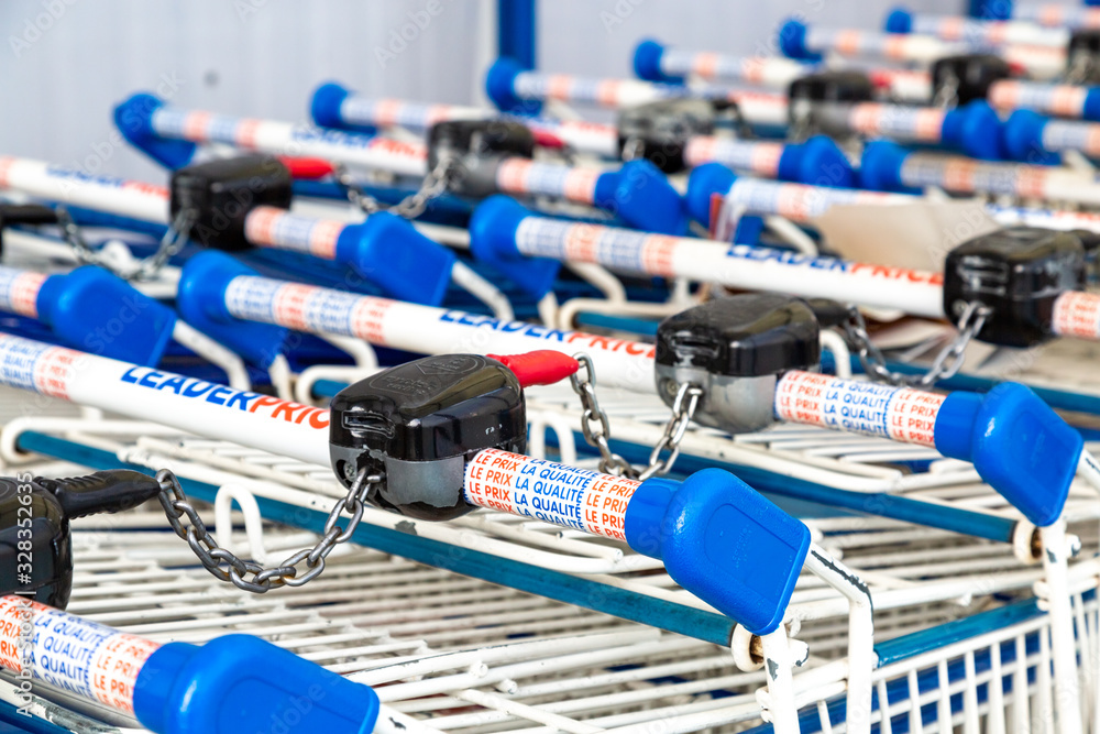 Leader Price Supermarket shopping trolleys aligned and stored in an ...