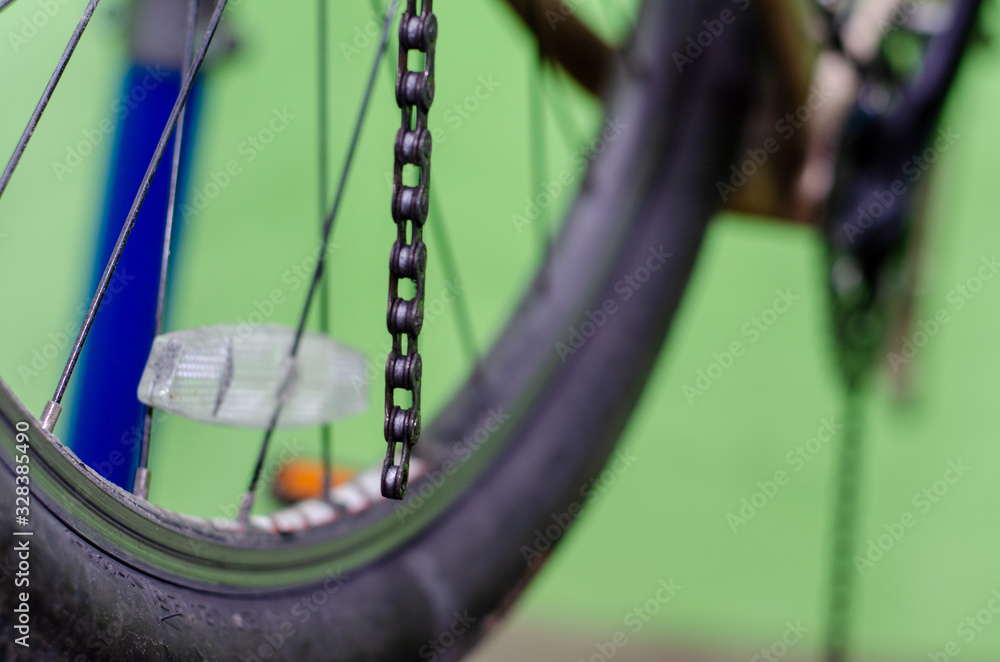 Repair mountain bike in the workshop. Replacing an old rusty chain with ...