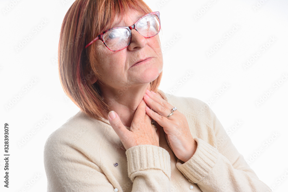 Female checking thyroid gland by herself. Close up of woman touching ...