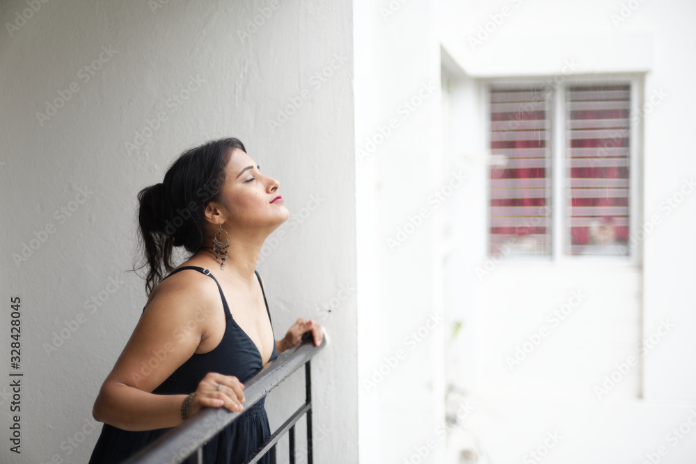 Portrait of a beautiful Indian Bengali brunette woman wearing a black ...
