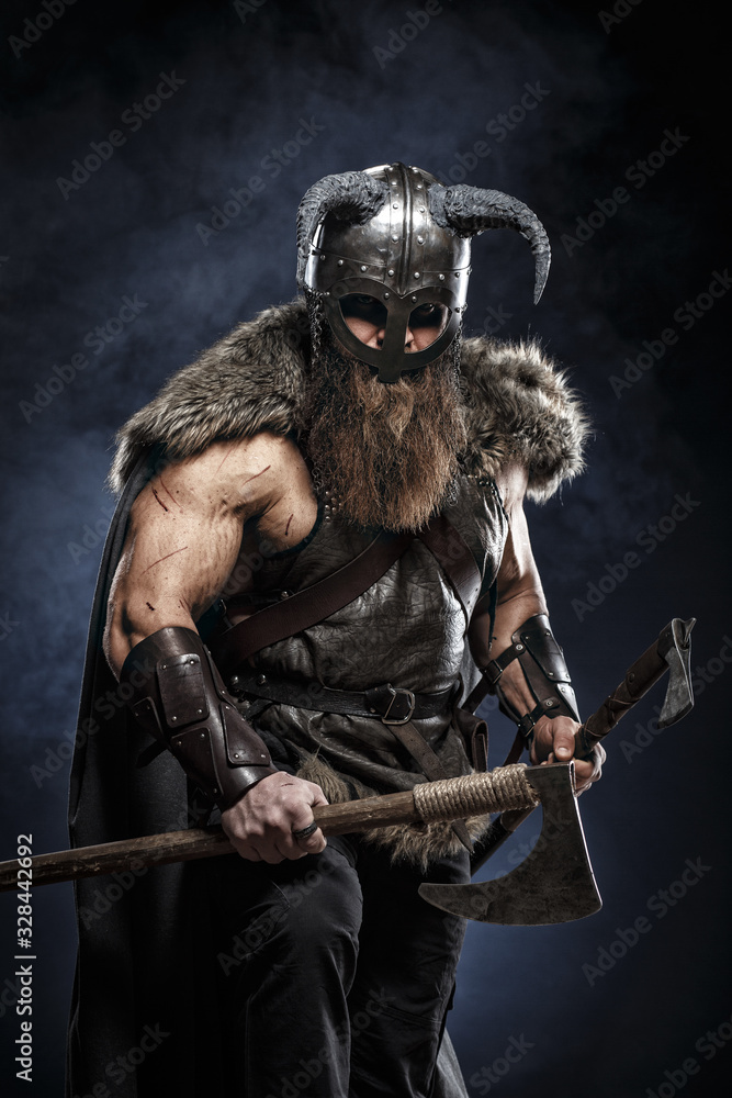 Medieval warrior berserk Viking with axes attacks enemy. Concept ...