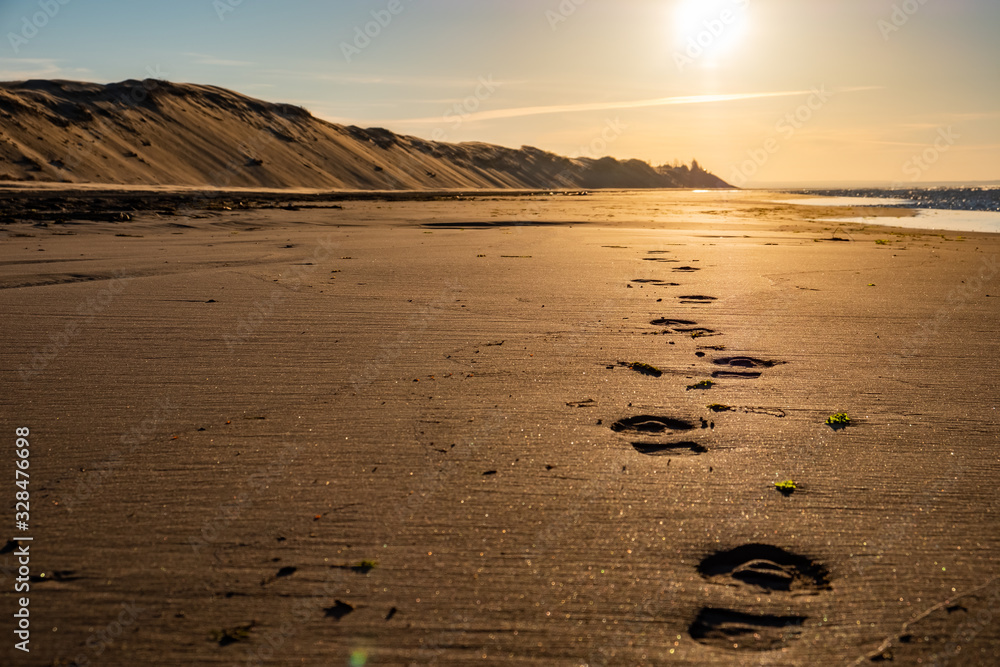 Boots footprints on a wet sand in perspective. Footprints on the beach ...