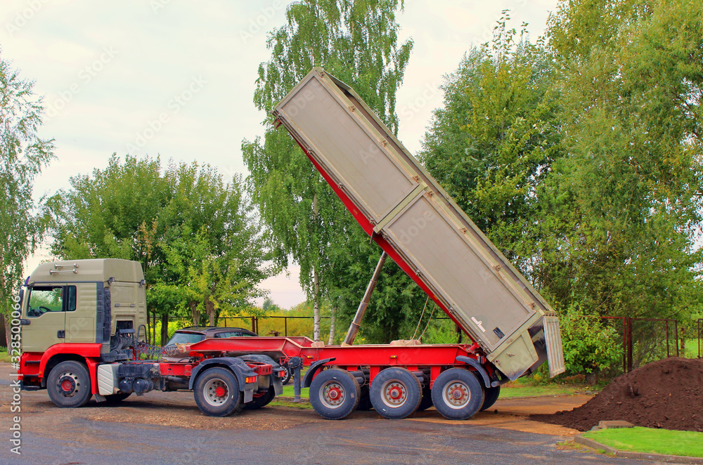 Big truck unloading the earth Stock Photo | Adobe Stock