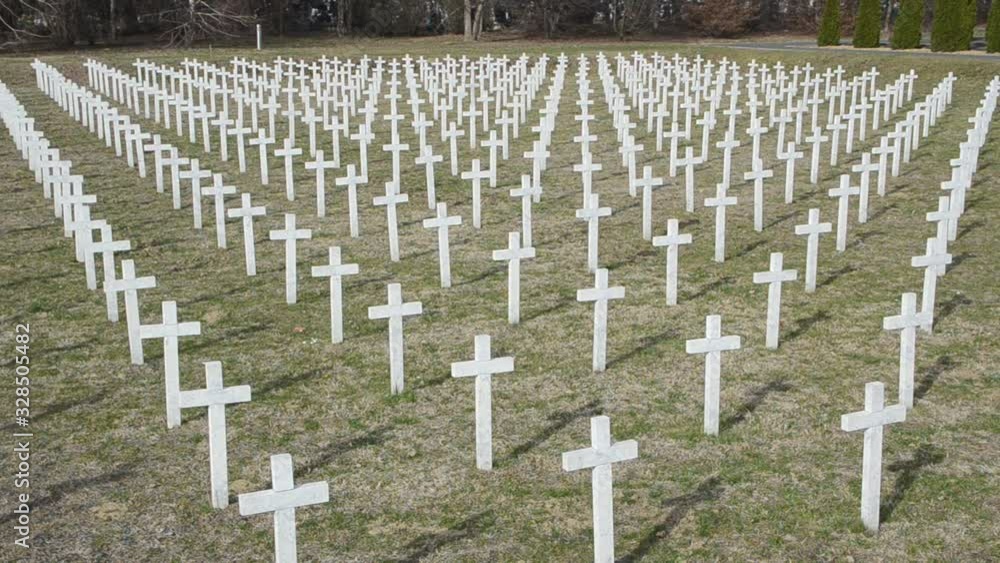 Military cemetery with white crosses. Headstones in War memorial ...