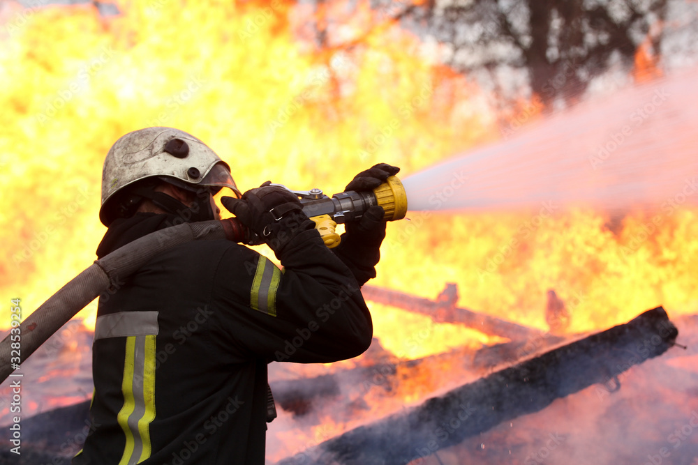 Brave firefighter saving burning building. Firefighter work concept ...