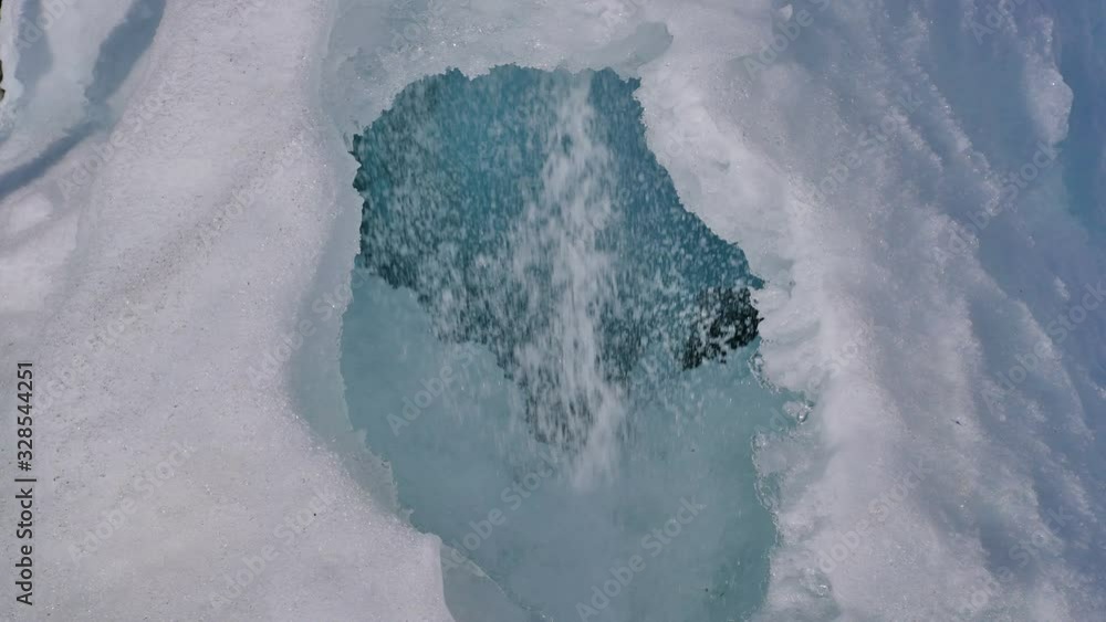 Spring melting of snow: ice texture in the rays of the setting sun with ...