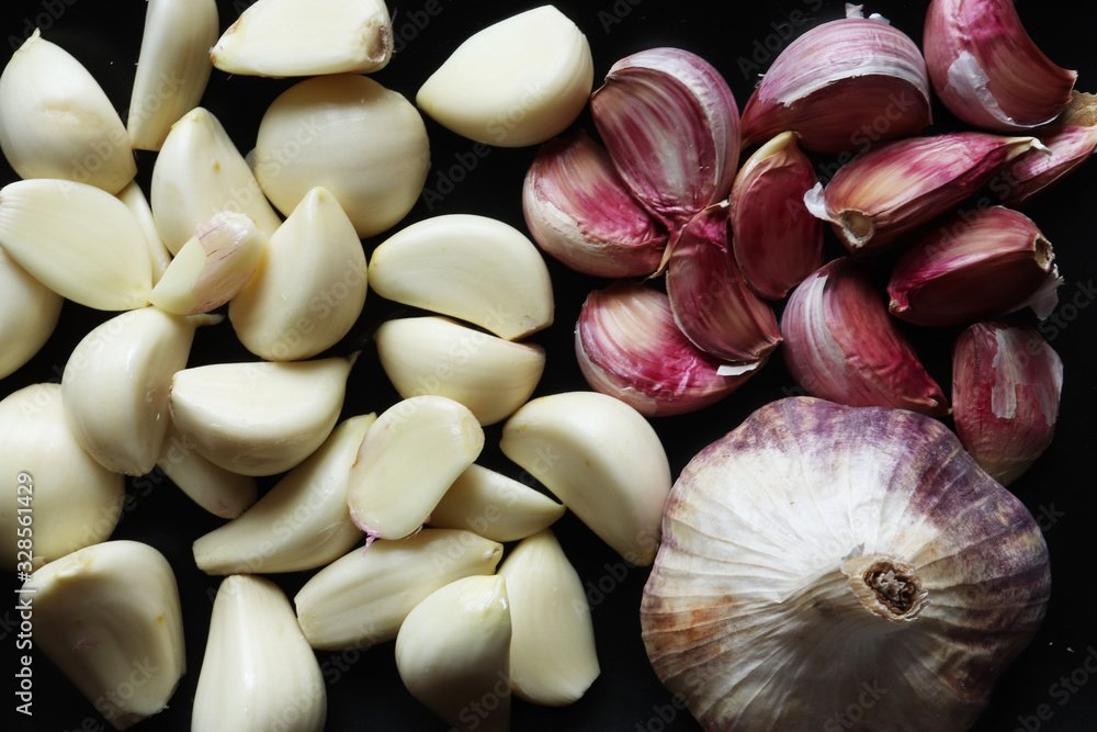 Photography of garlic cloves, peeled garlic cloves and head of garlic ...