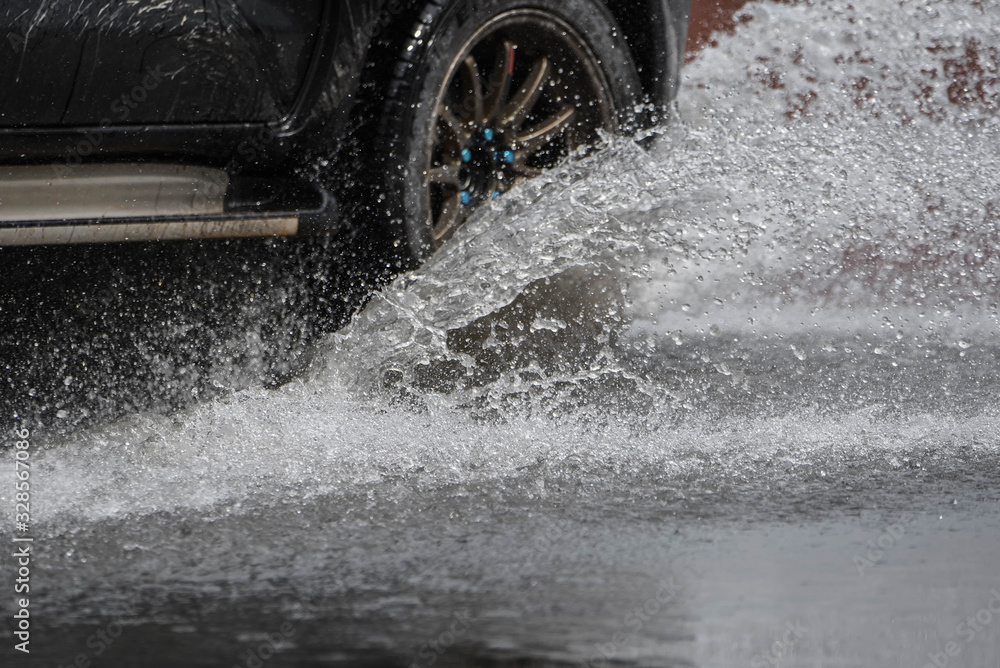 Splash of water from car tire, be careful to drive concept. Stock Photo ...