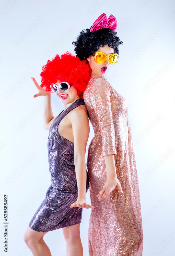 Two glamorous and beautiful girls in bright clothes, having fun ...