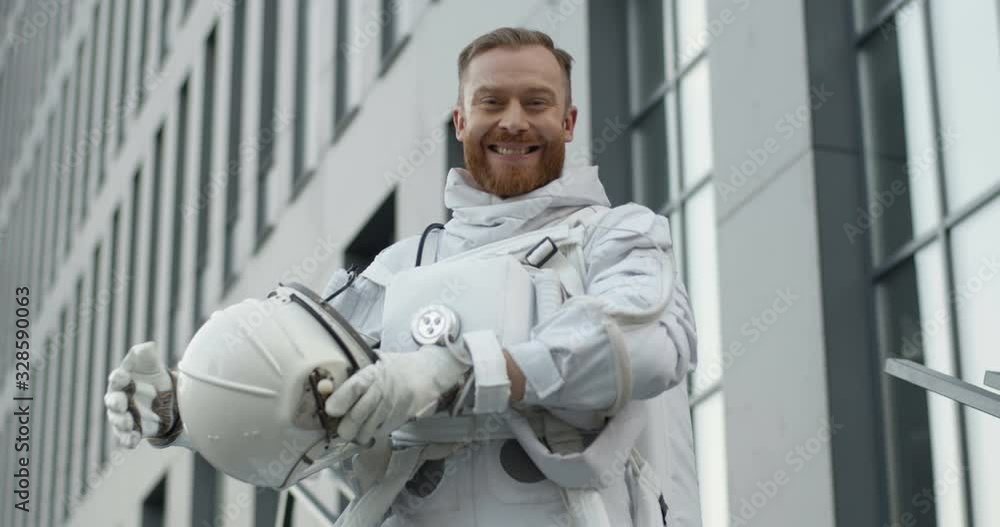 Portrait shot of handsome young Caucasian man astronaut in space suit ...