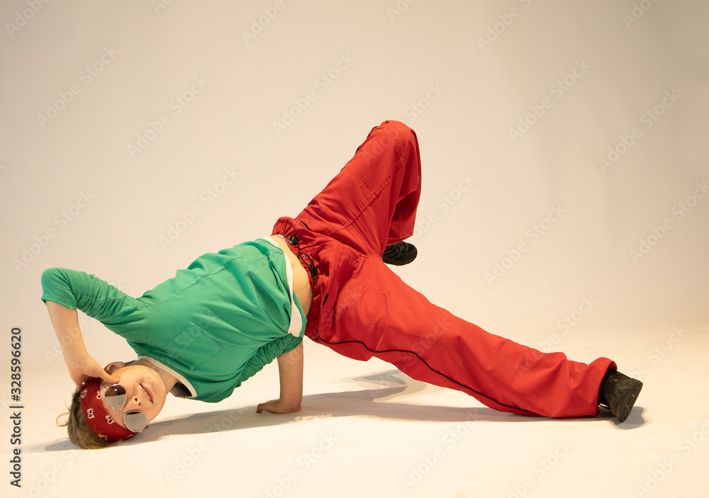 a little boy in a unique breakdance pose, a unique dance position, a ...